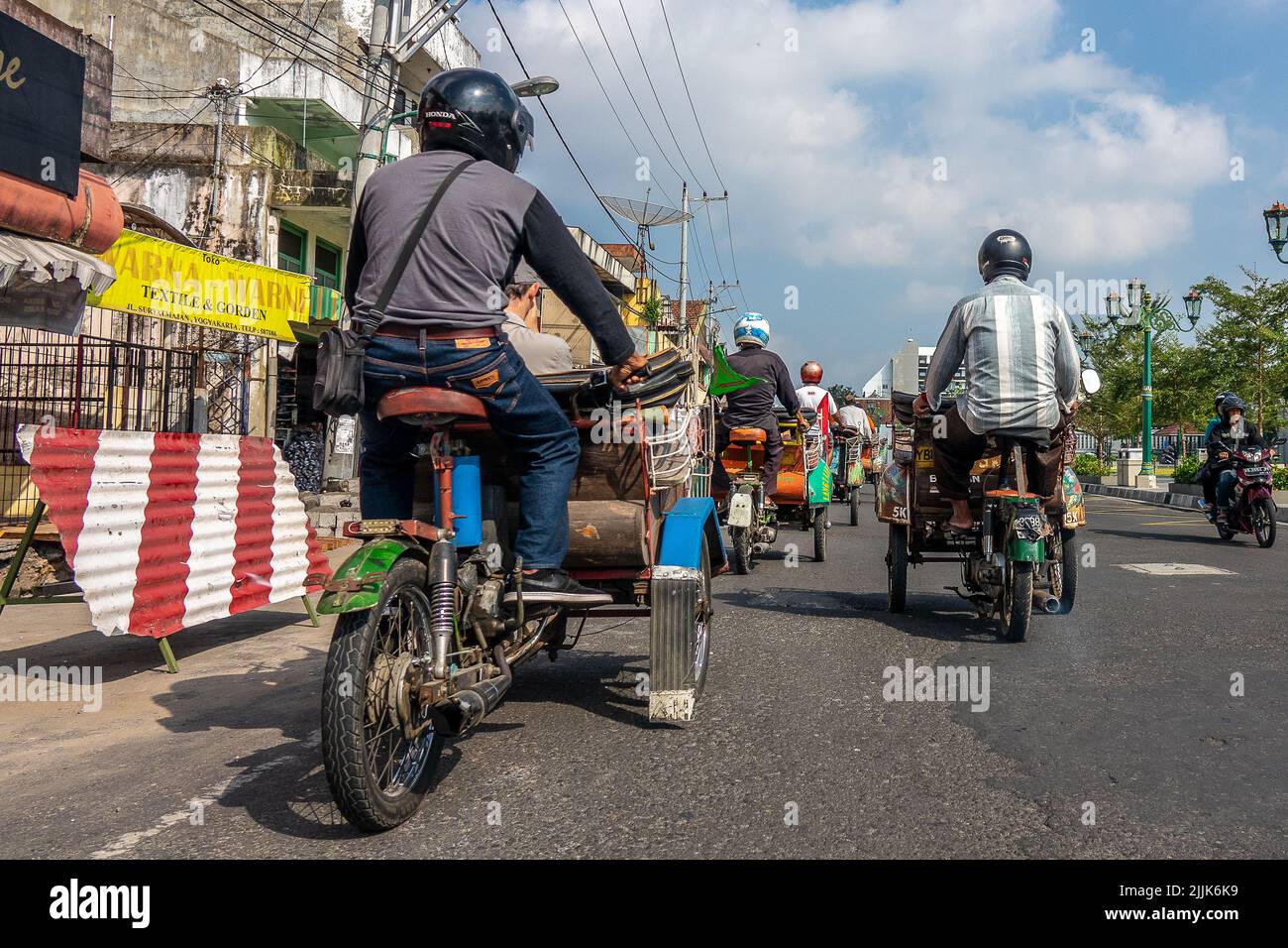The taxi drivers driving motorized bikes in the streets of Jakarta ...