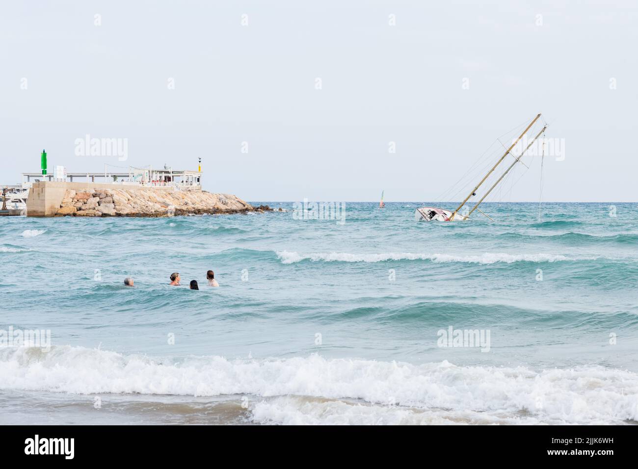 Sailboat stranded near the entrance to the port as a result of getting ...