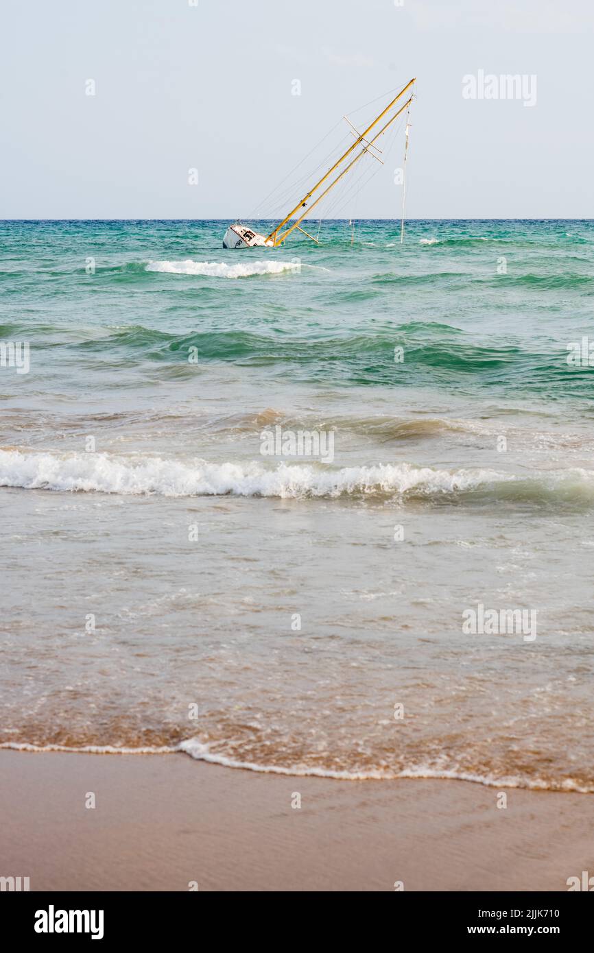Sailboat stranded near the entrance to the port as a result of getting ...