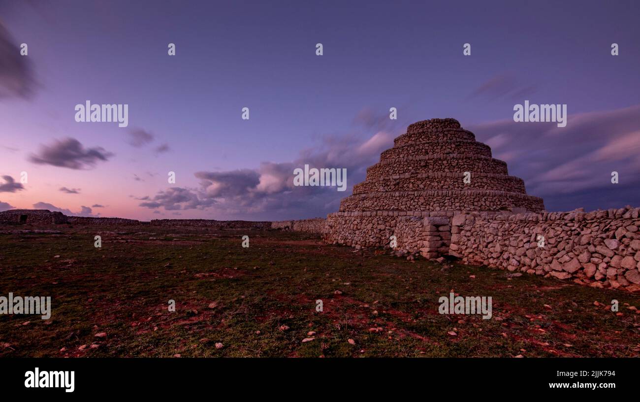 A scenic view of a stone structure in colorful sunset sky background ...
