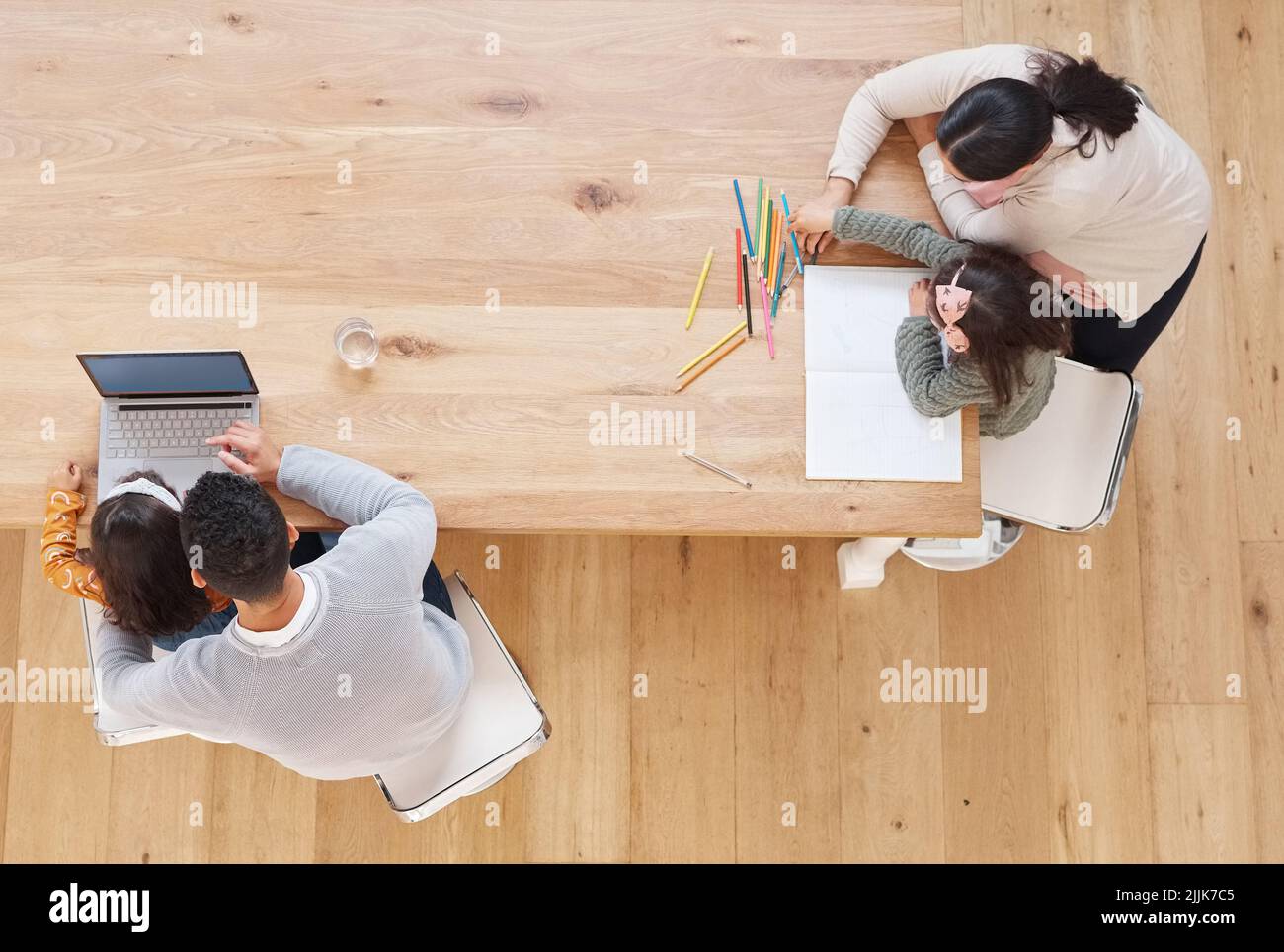 A family that studies together grows together. two parents helping ...