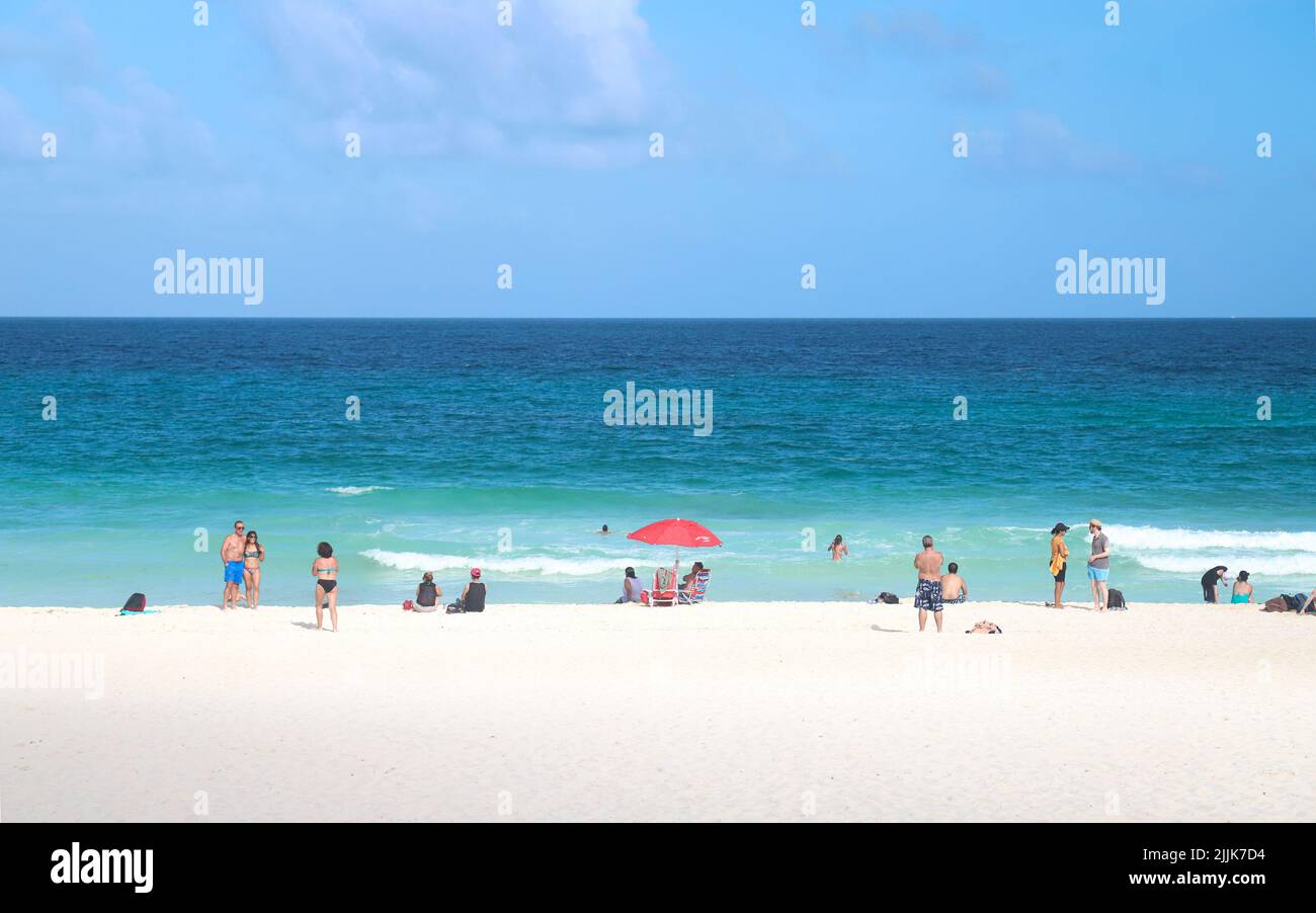 Tourists relax at a colorful scenic beach in Cancun on Mexico's Yucatan ...
