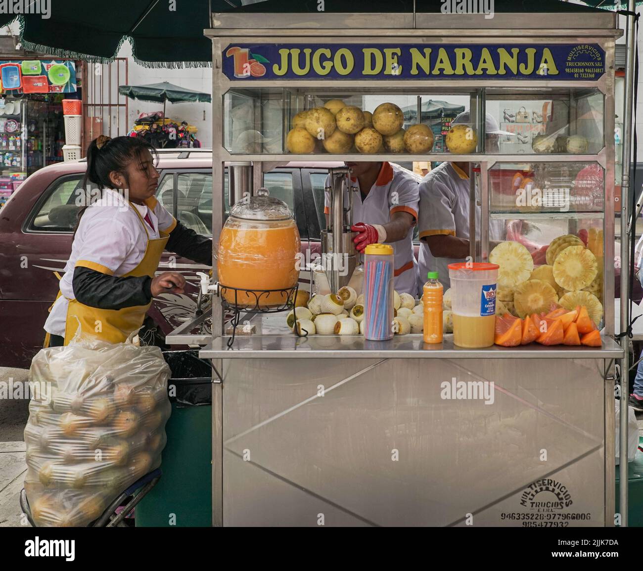 A closeup of an orange juice stand outside the Mercado Central in Lima ...
