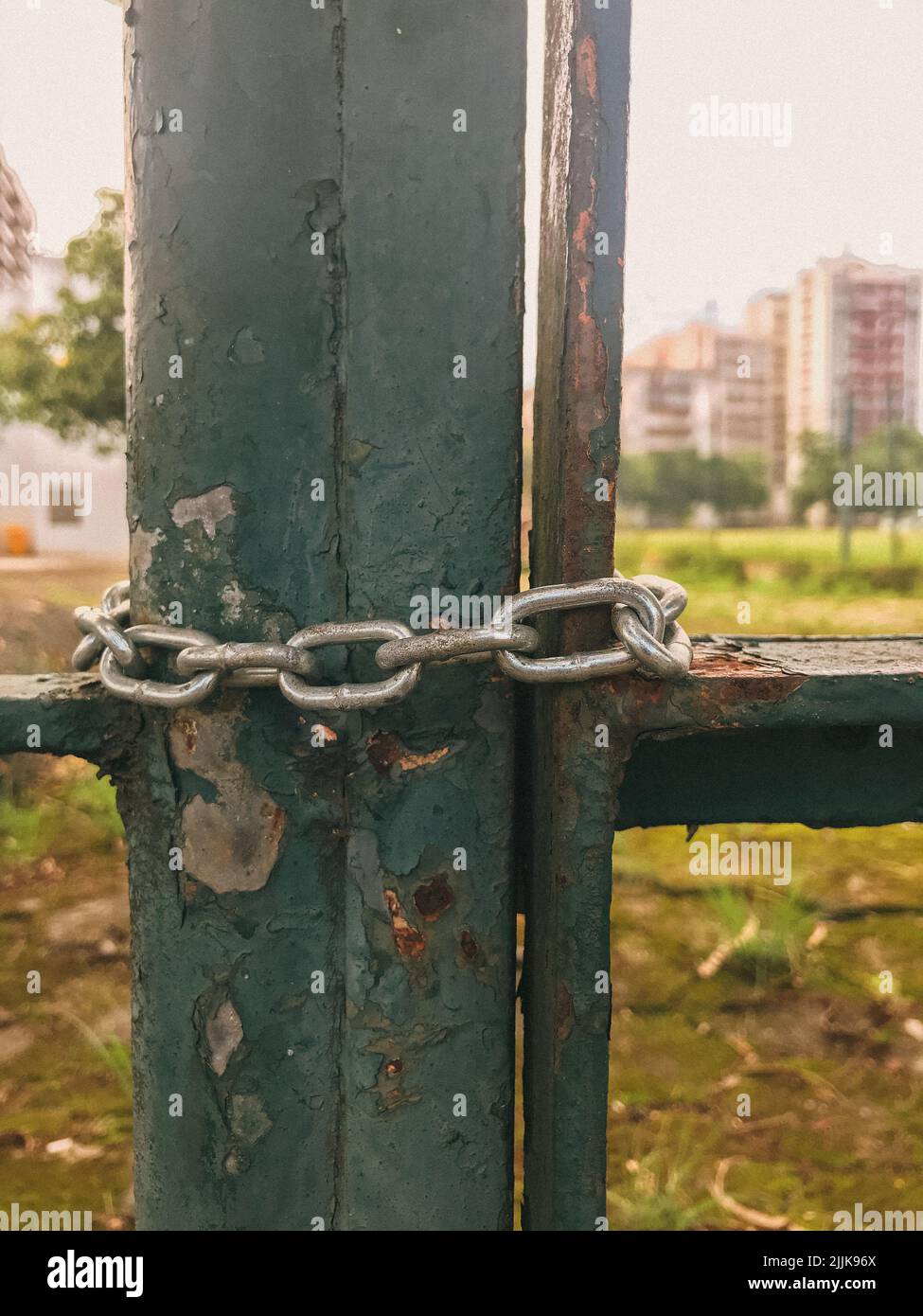 The Closed gate with a big steel chain and padlock Stock Photo - Alamy