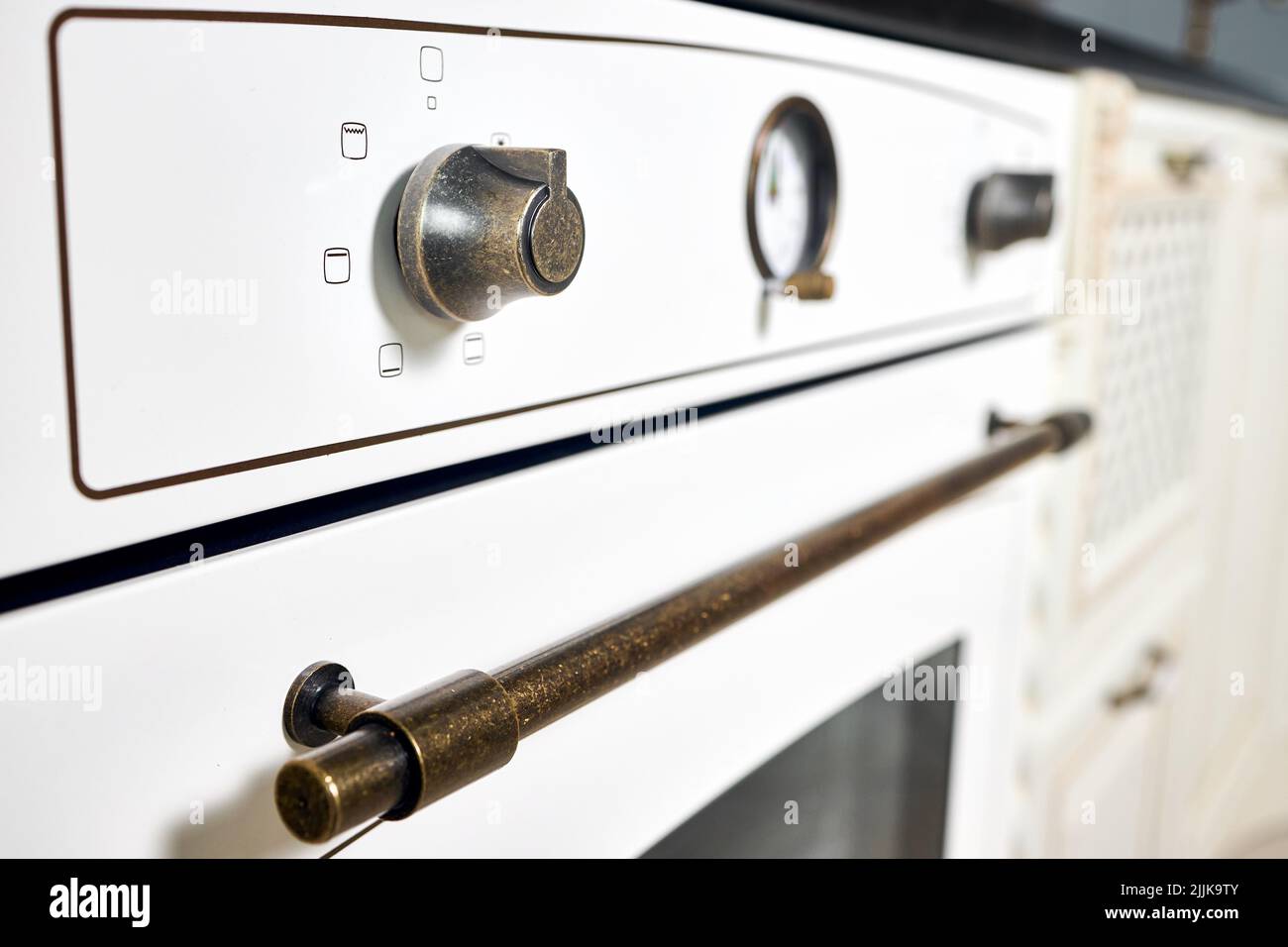 Modern built-in oven with brass regulator and handle with patina and ...