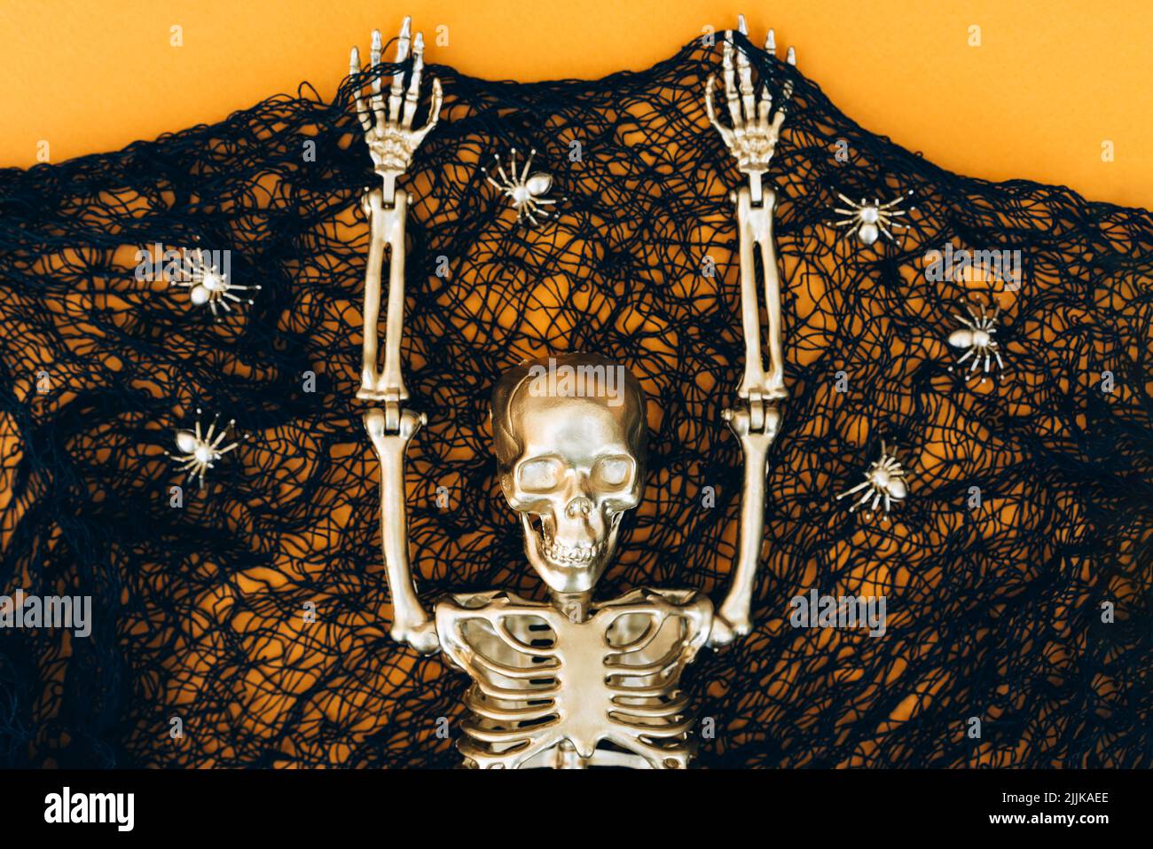 Halloween background with black cobweb, spiders and golden skeleton ...