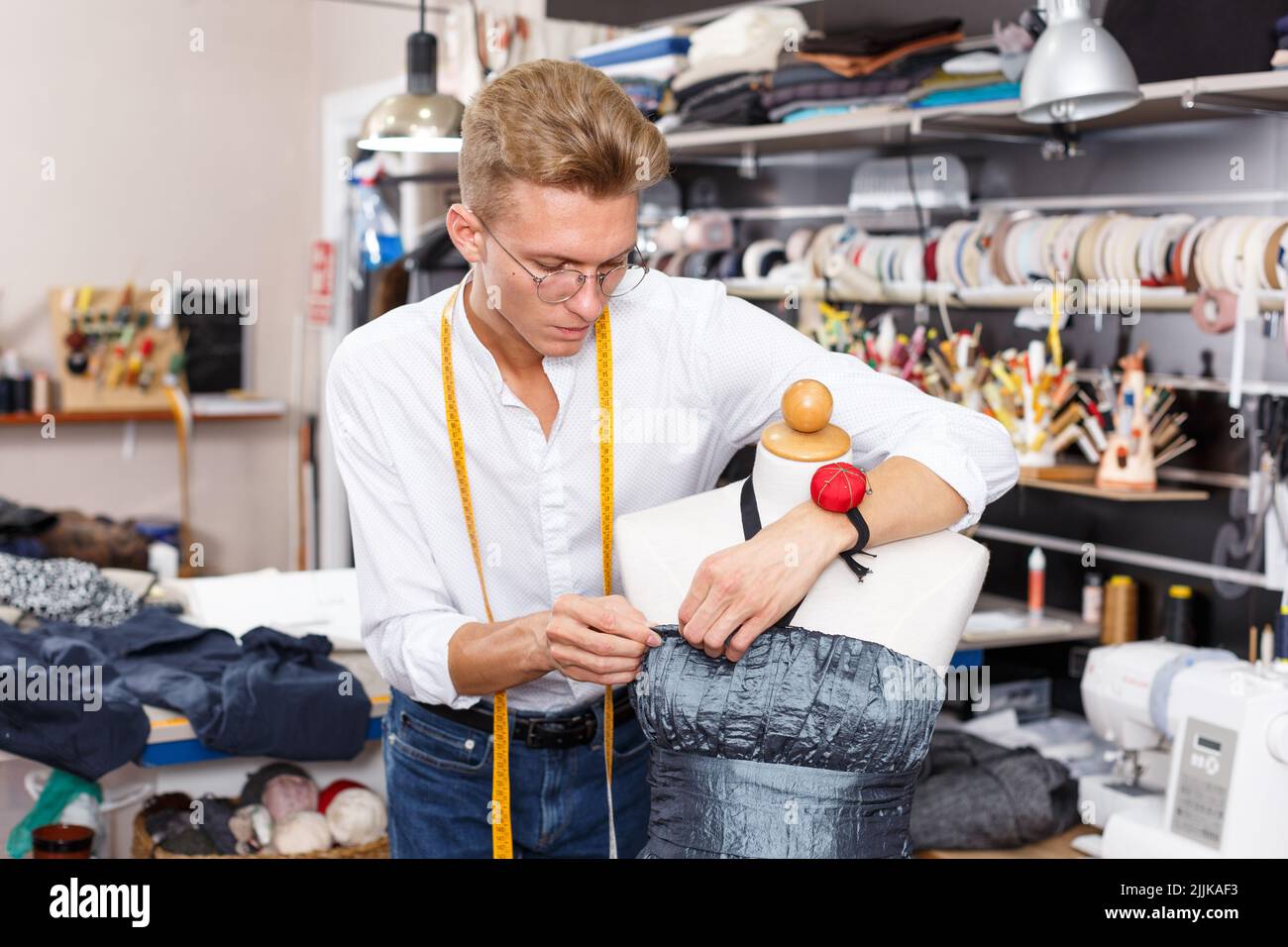 Dressmaker using tape measure Stock Photo - Alamy
