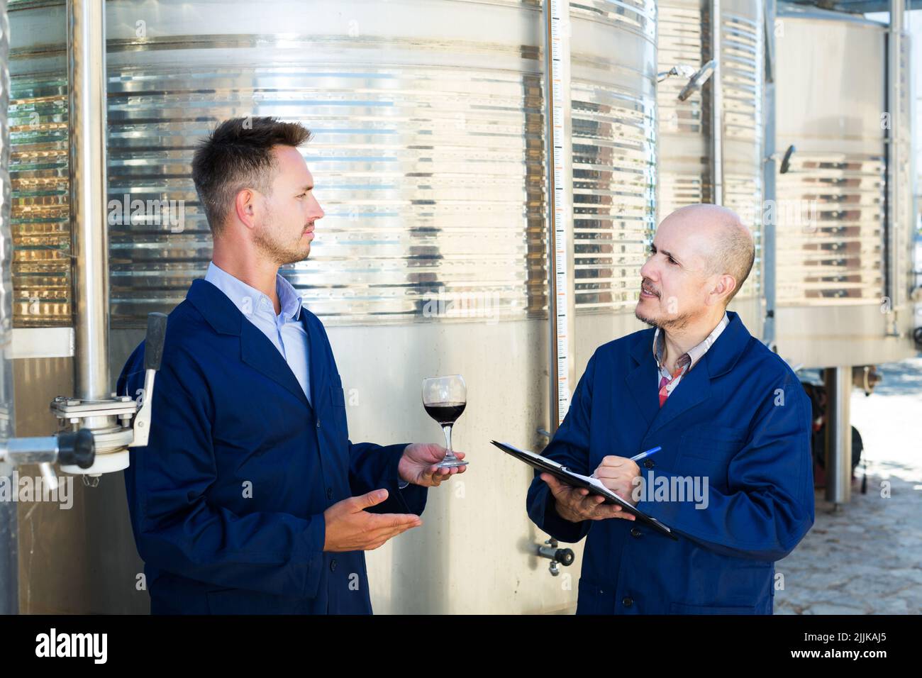 Workers taking notes wine sample Stock Photo - Alamy