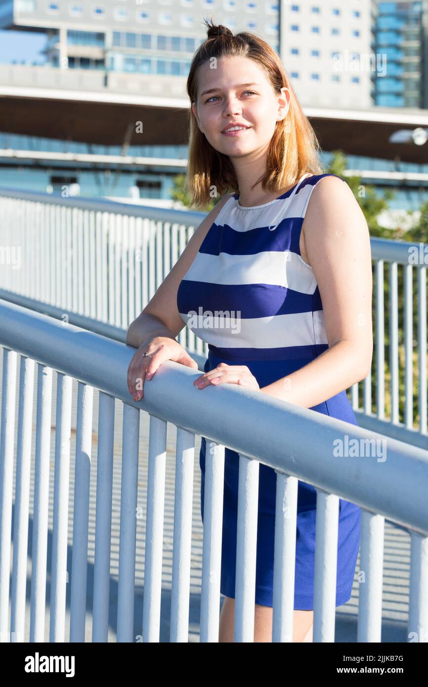 Smiling girl standing on bridge Stock Photo - Alamy