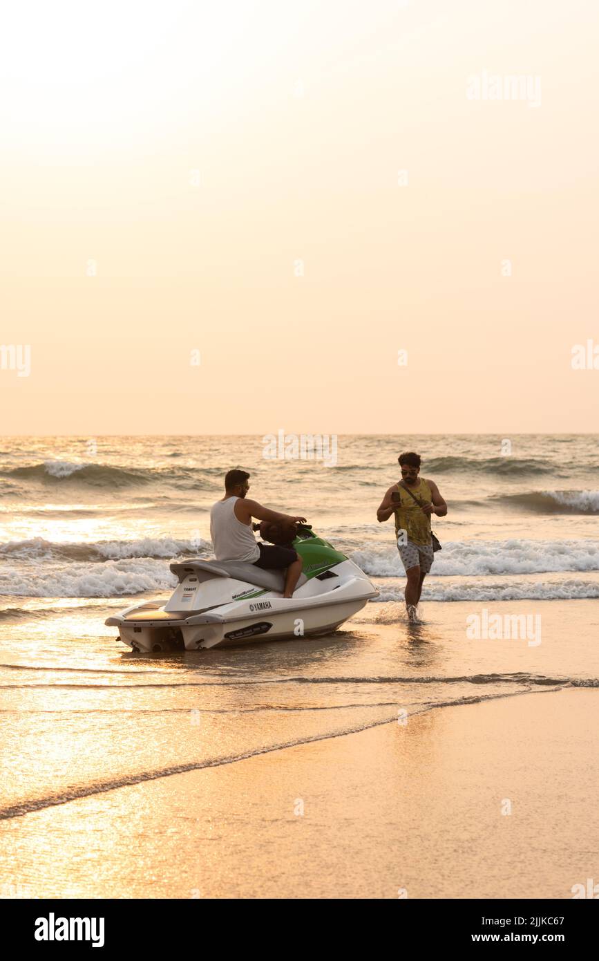 A vertical shot of two young Indian men at Ashwem Beach in Goa India ...