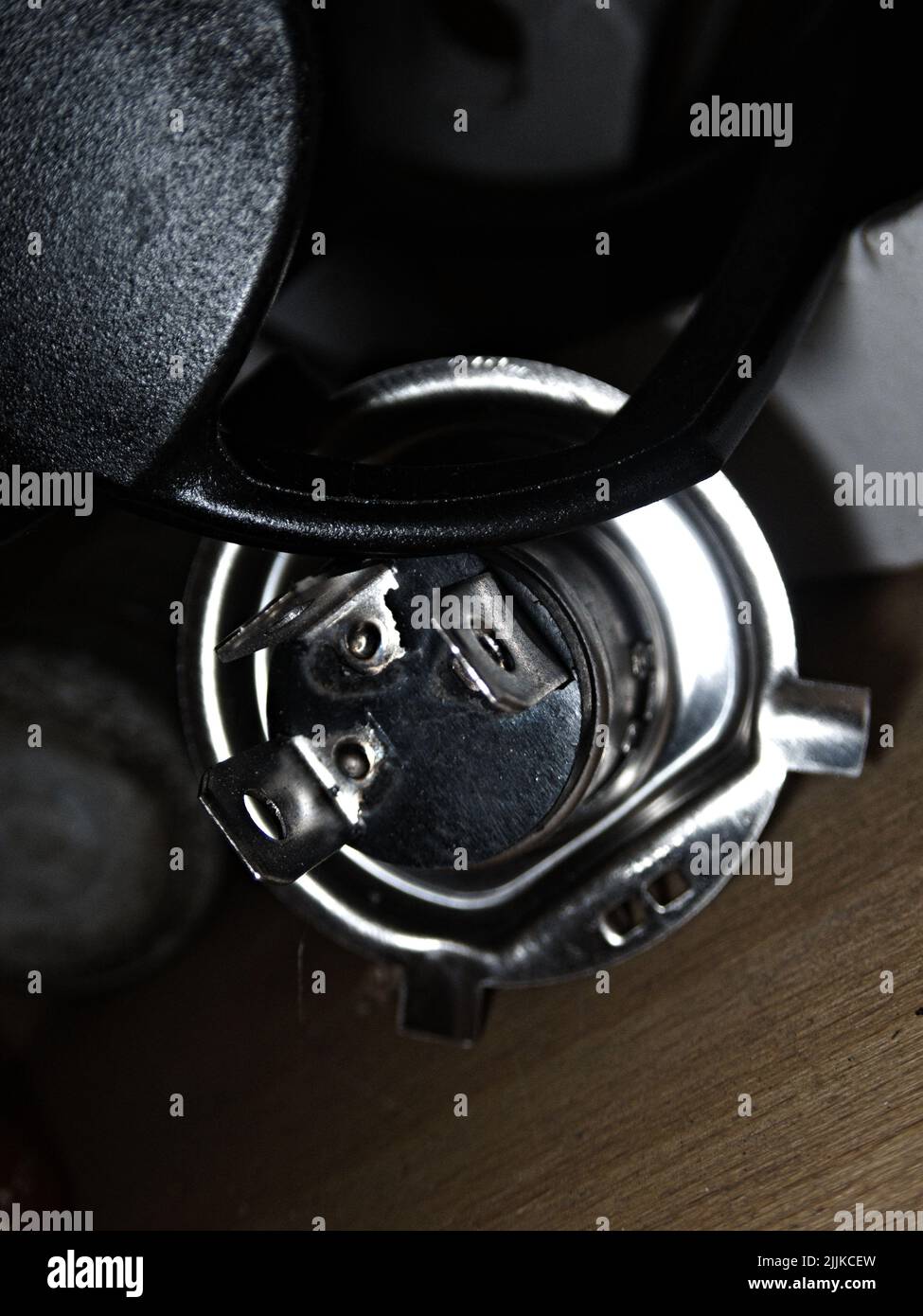 A vertical shot of a shiny circuit male plug on a wooden surface Stock ...