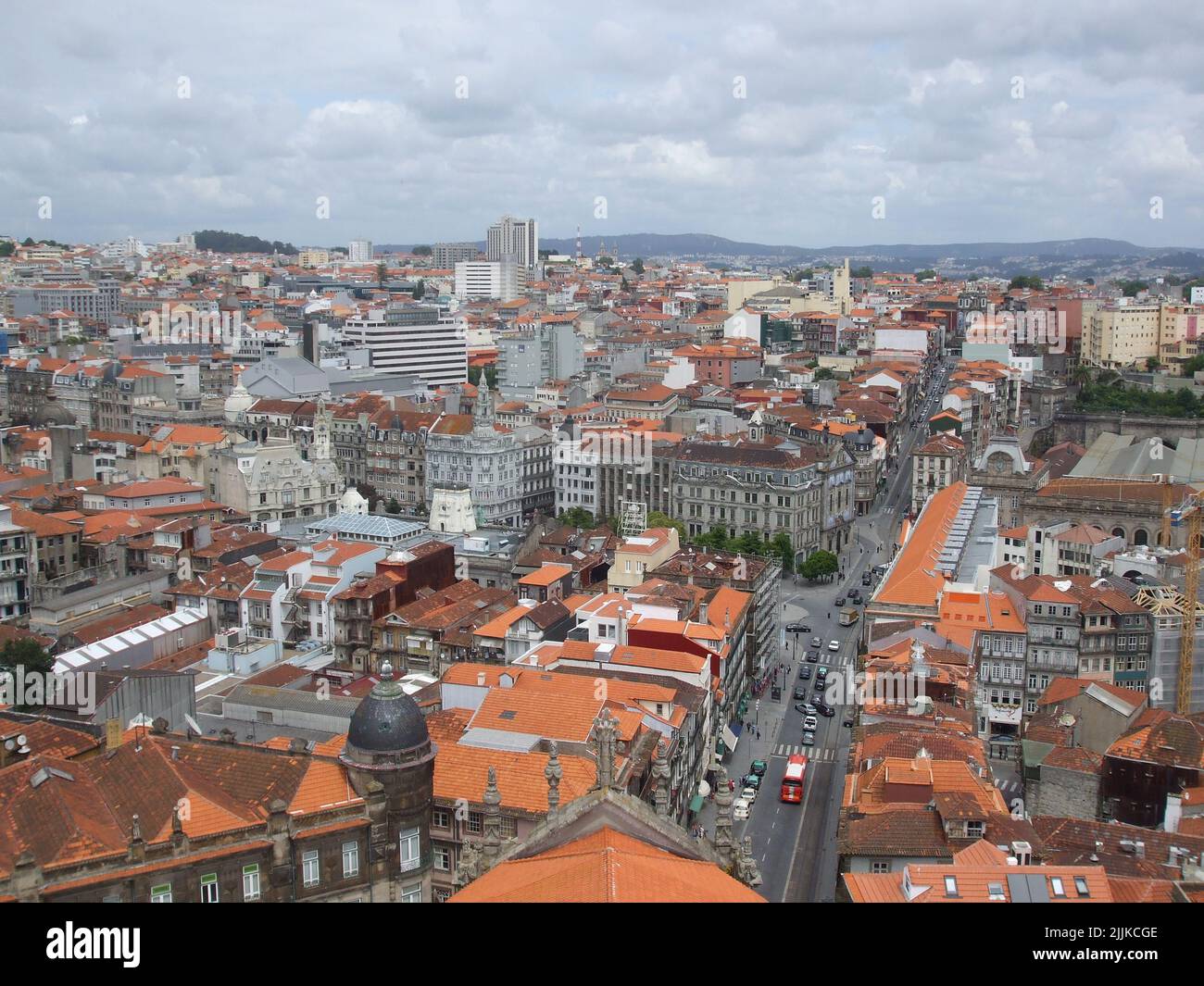 An aerial shot of buildings with red roofs and streets of Braga city in ...