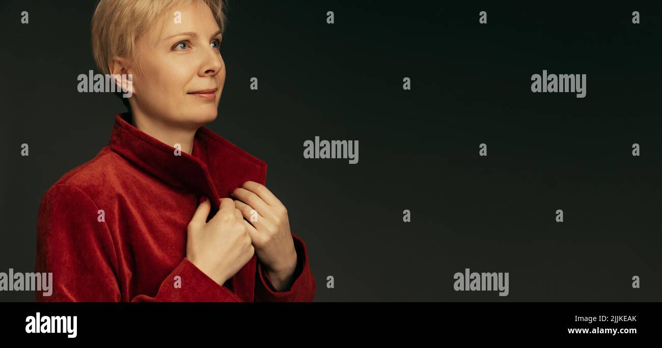 Portrait of beautiful middle-aged woman in stylish red velvet jacket ...