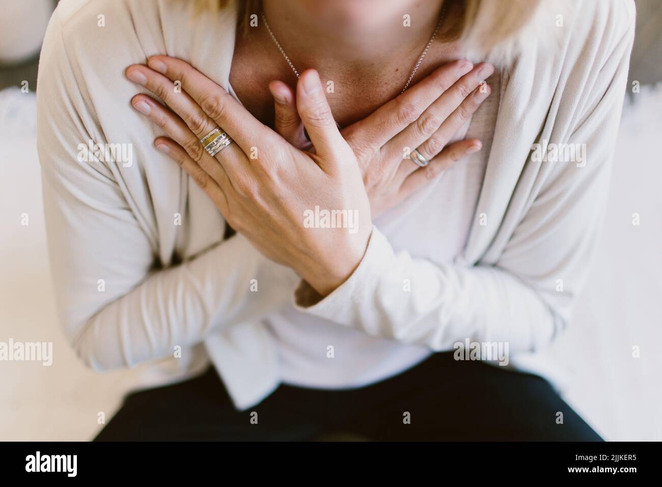 A close-up shot of a woman keeping her crossed arms on her chest Stock ...