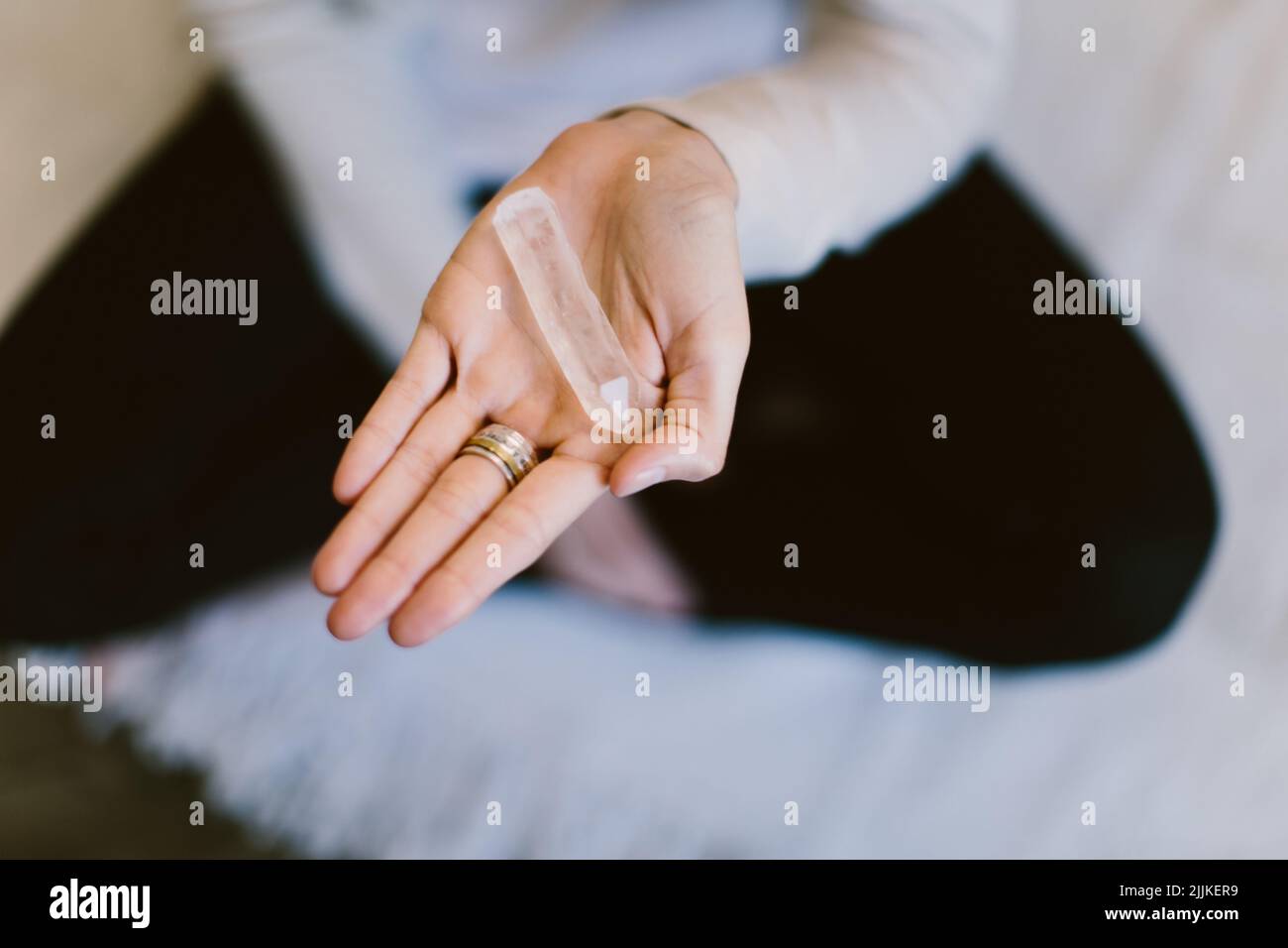 A female's hand holding a transparent crystal Stock Photo - Alamy