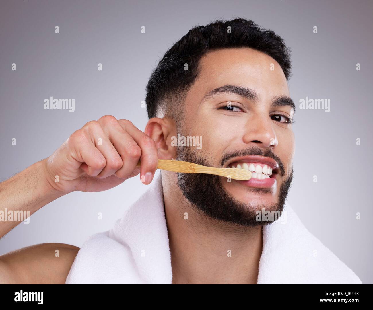 Keeping away those oral nasties. a handsome young man brushing his ...