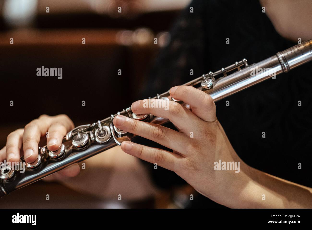 A musician playing the flute at a concert Stock Photo - Alamy