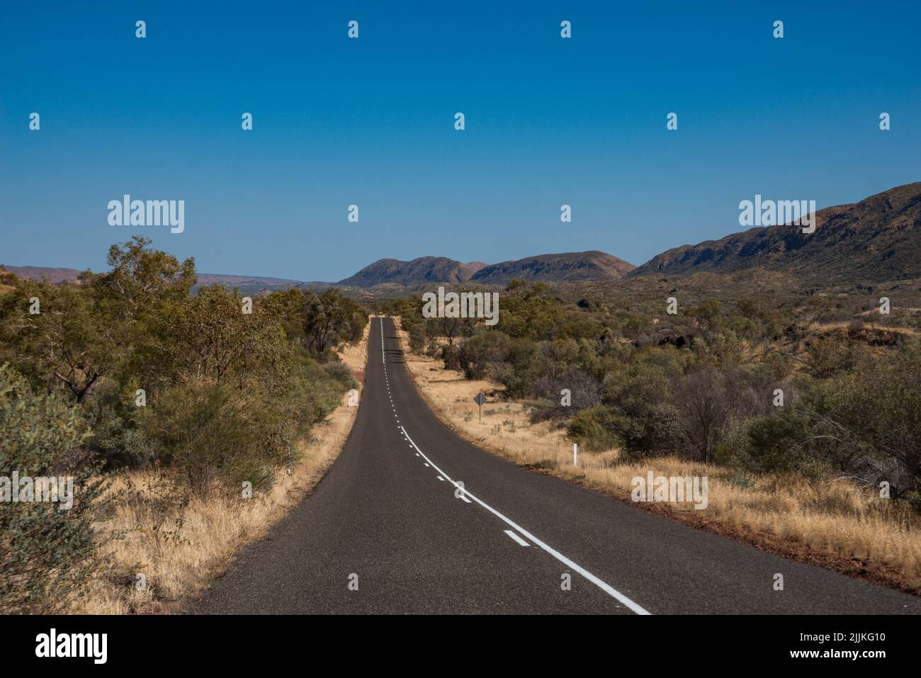 A perspective shot of a road next to a wild landscape Stock Photo - Alamy