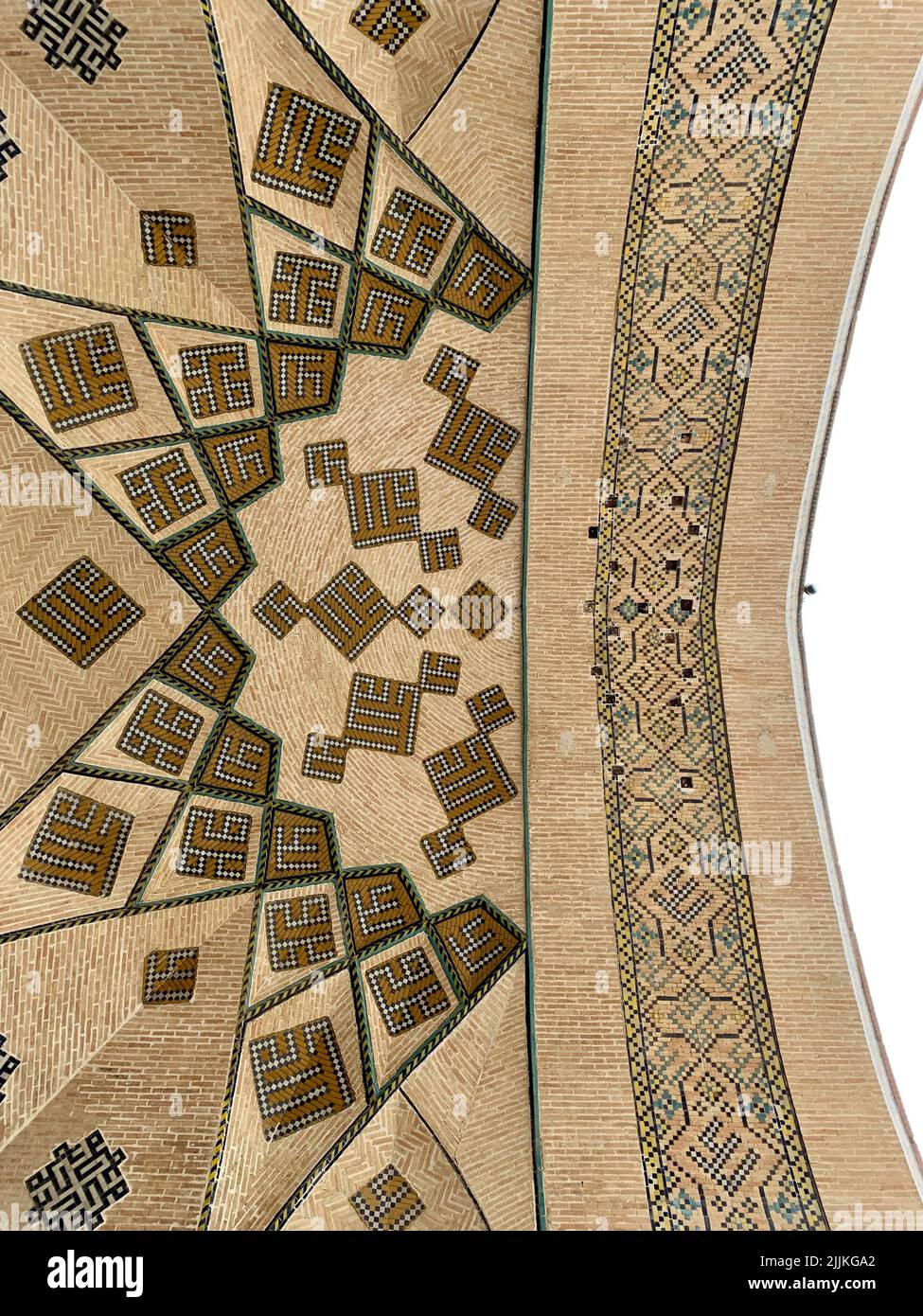 A vertical low angle shot of the arch of the Shah Mosque in Isfahan ...