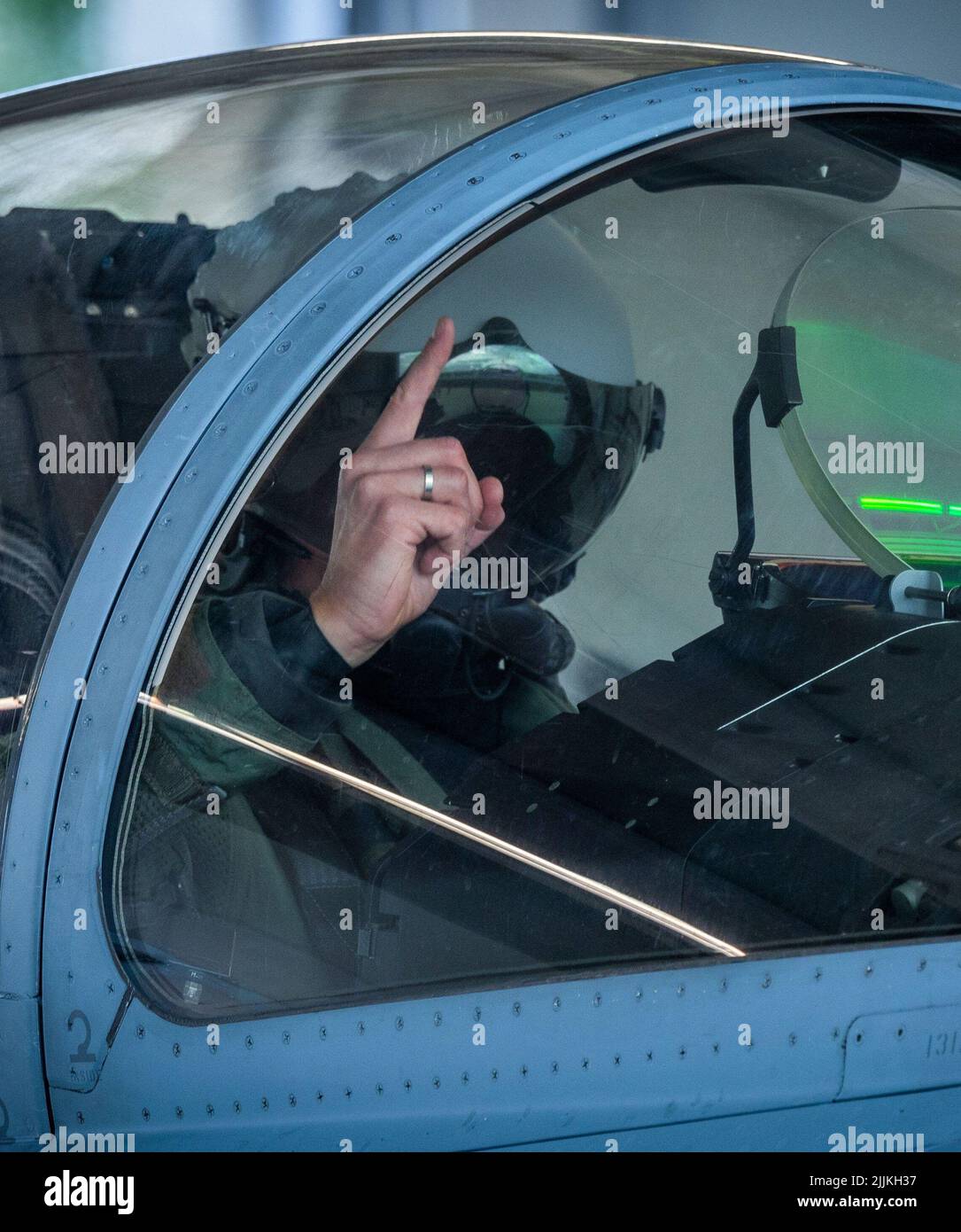 Laage, Germany. 27th July, 2022. A Bundeswehr pilot gives hand signals ...