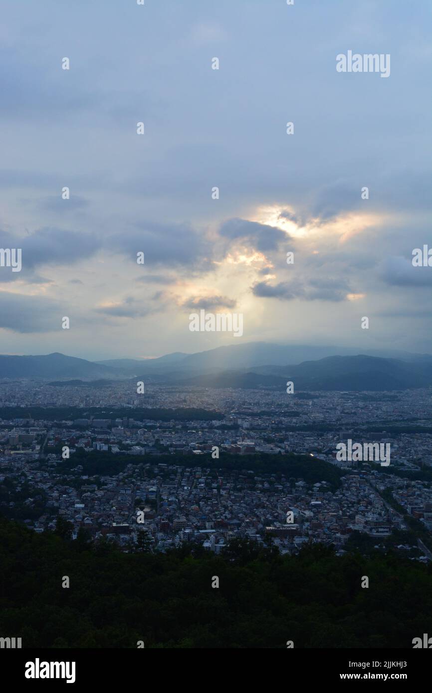 The Kyoto cityscape with sun rays through the clouds in Japan Stock ...