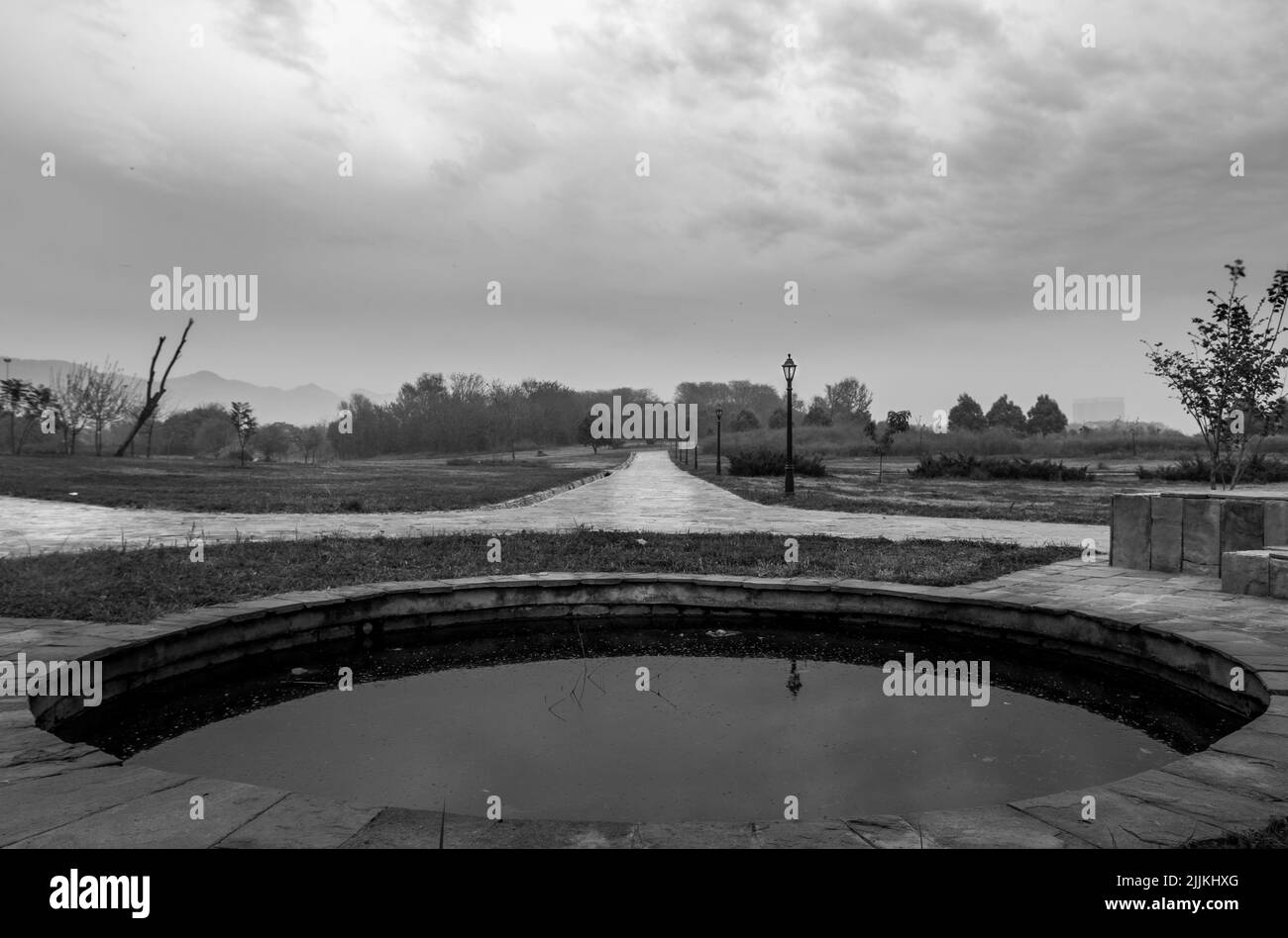 A grayscale of the park with trees and hills in the background Stock ...