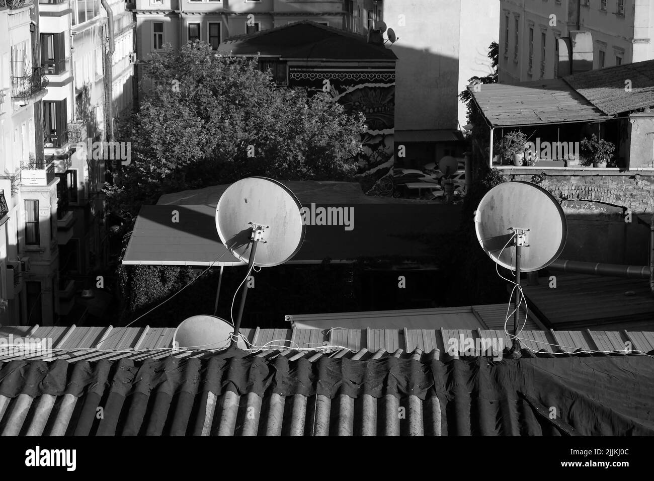 A grayscale of tv antennas on the roof Stock Photo - Alamy