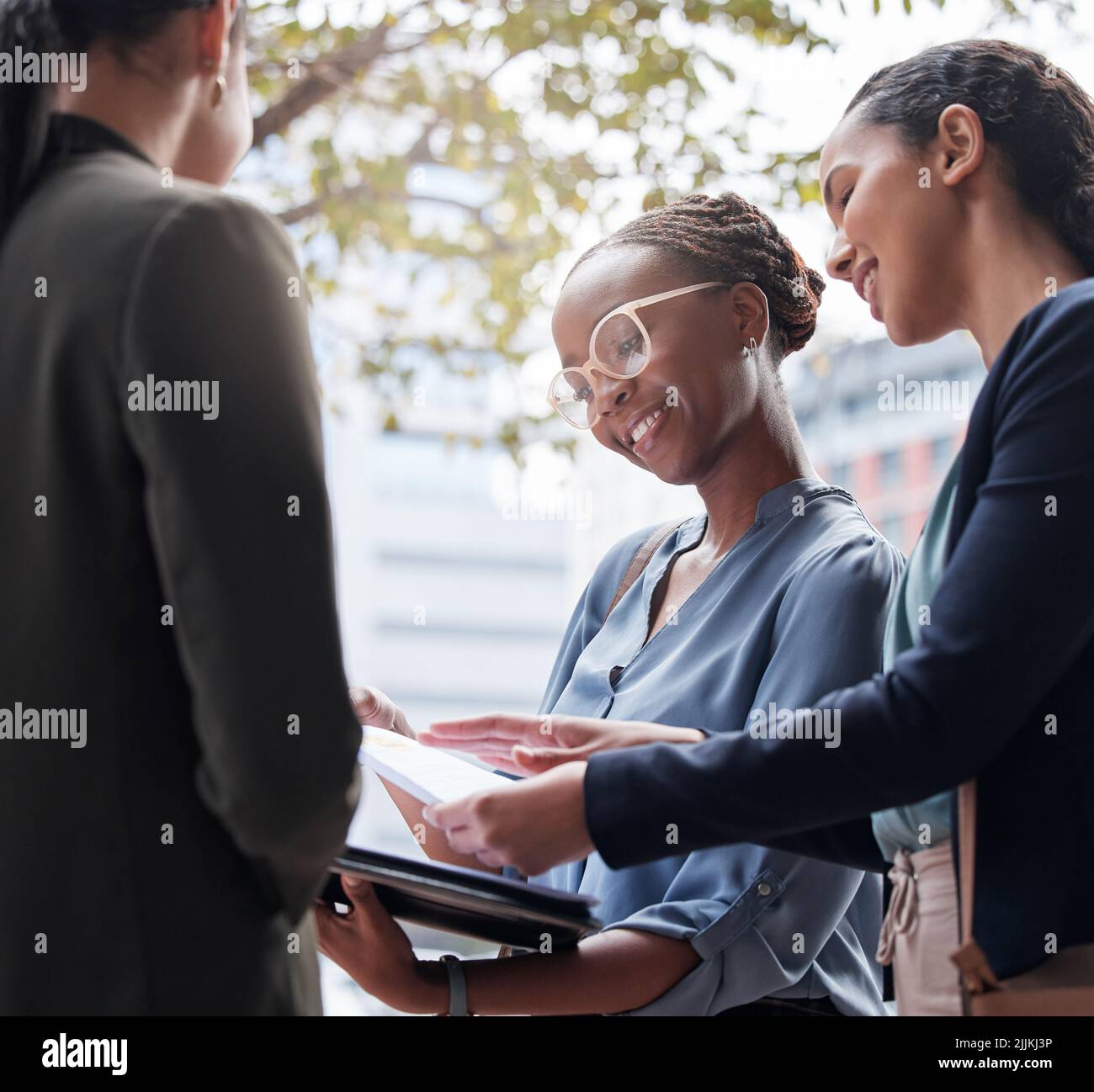 Sharing new ideas. a group of businesswomen going through paperwork ...