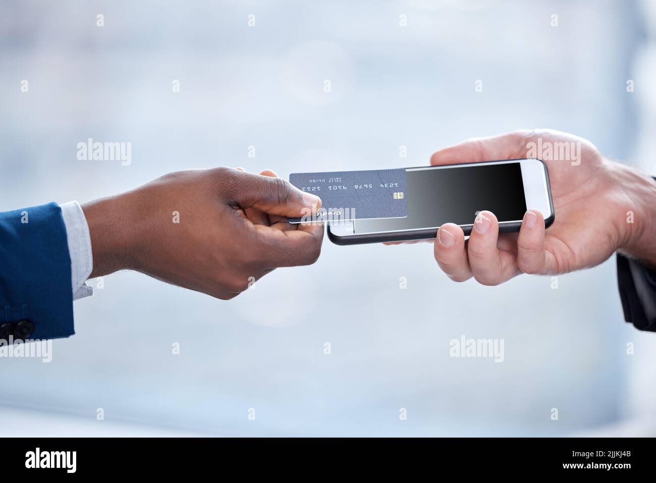 You can tap to pay now. Shot two unrecognizable people doing a payment ...