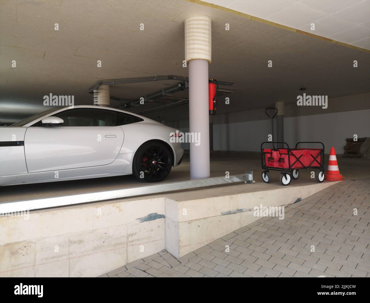 A white car parked in a parking lot in daylight Stock Photo - Alamy