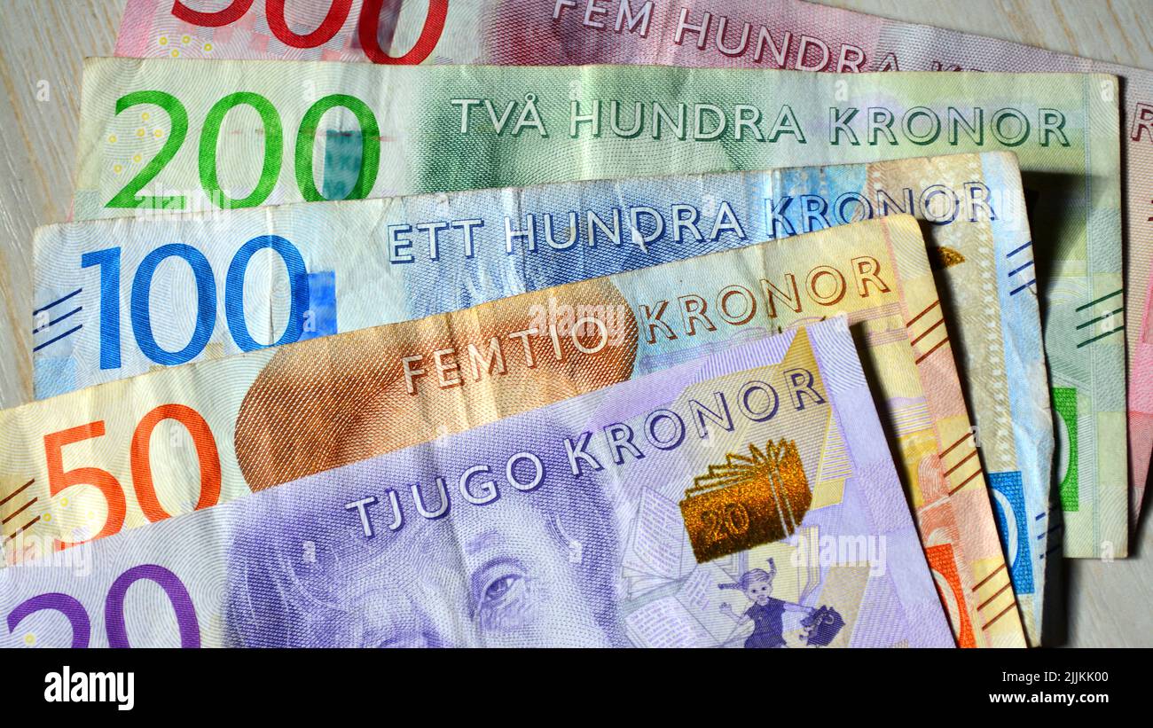 A close-up top shot of Swedish banknotes on a wooden surface Stock ...