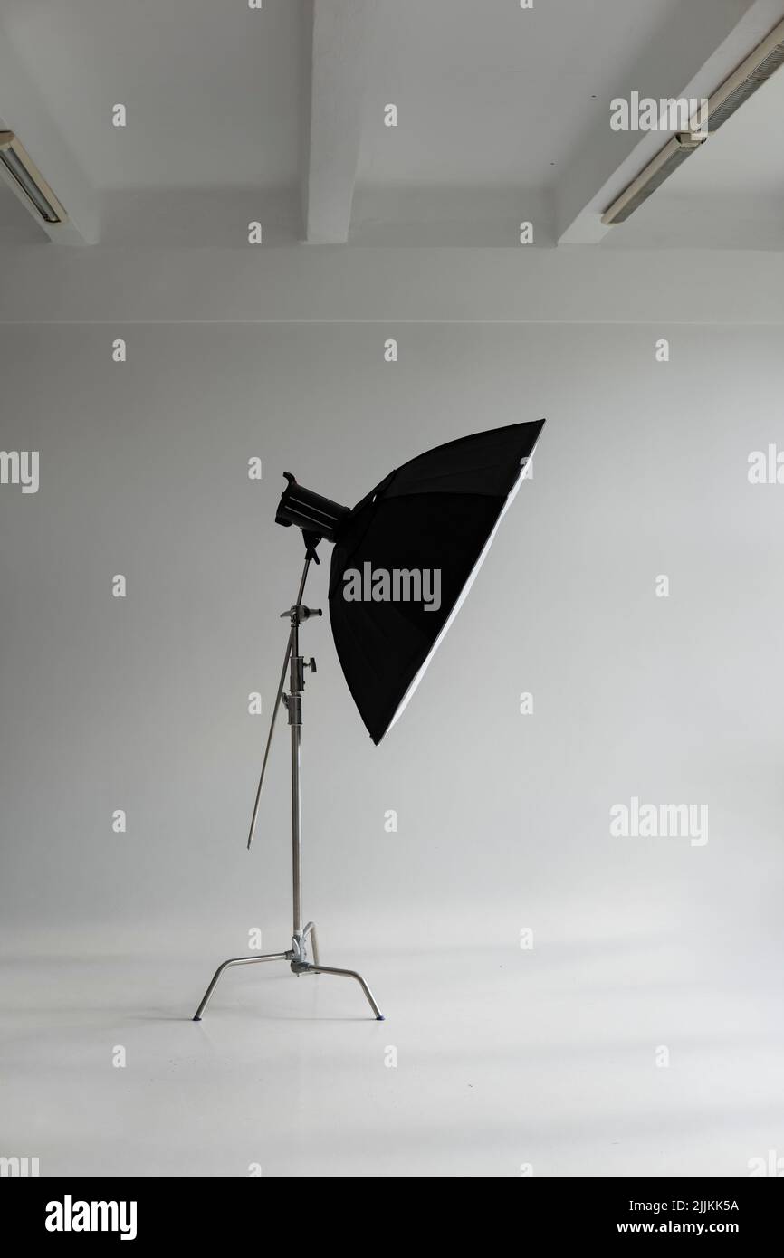 Professional photo flash light with a big softbox on a c-stand on a ...