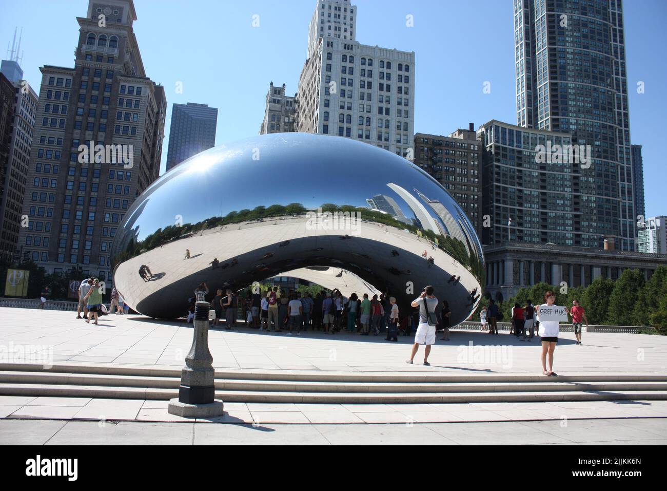 A beautiful shot of tourists taking photos of the Cloud Gate monument ...