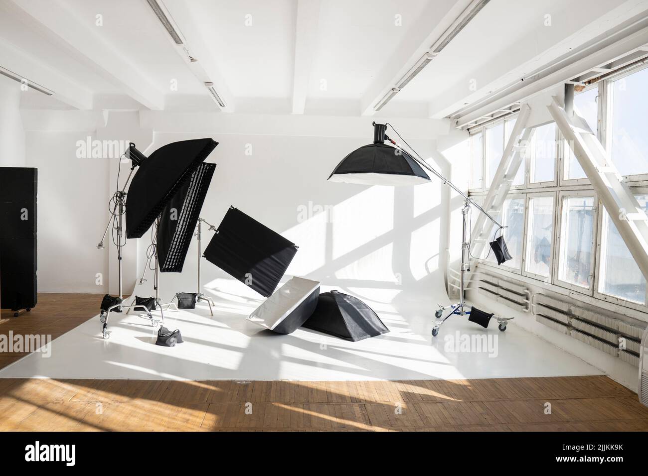 Professional lighting equipment, flashes, c-stands on a cyclorama in ...