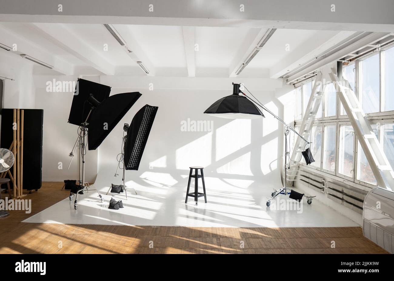 Professional lighting equipment, flashes, c-stands on a cyclorama in ...