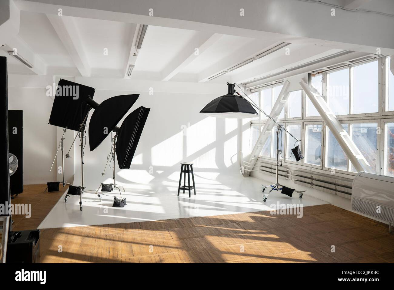 Professional lighting equipment, flashes, c-stands on a cyclorama in ...