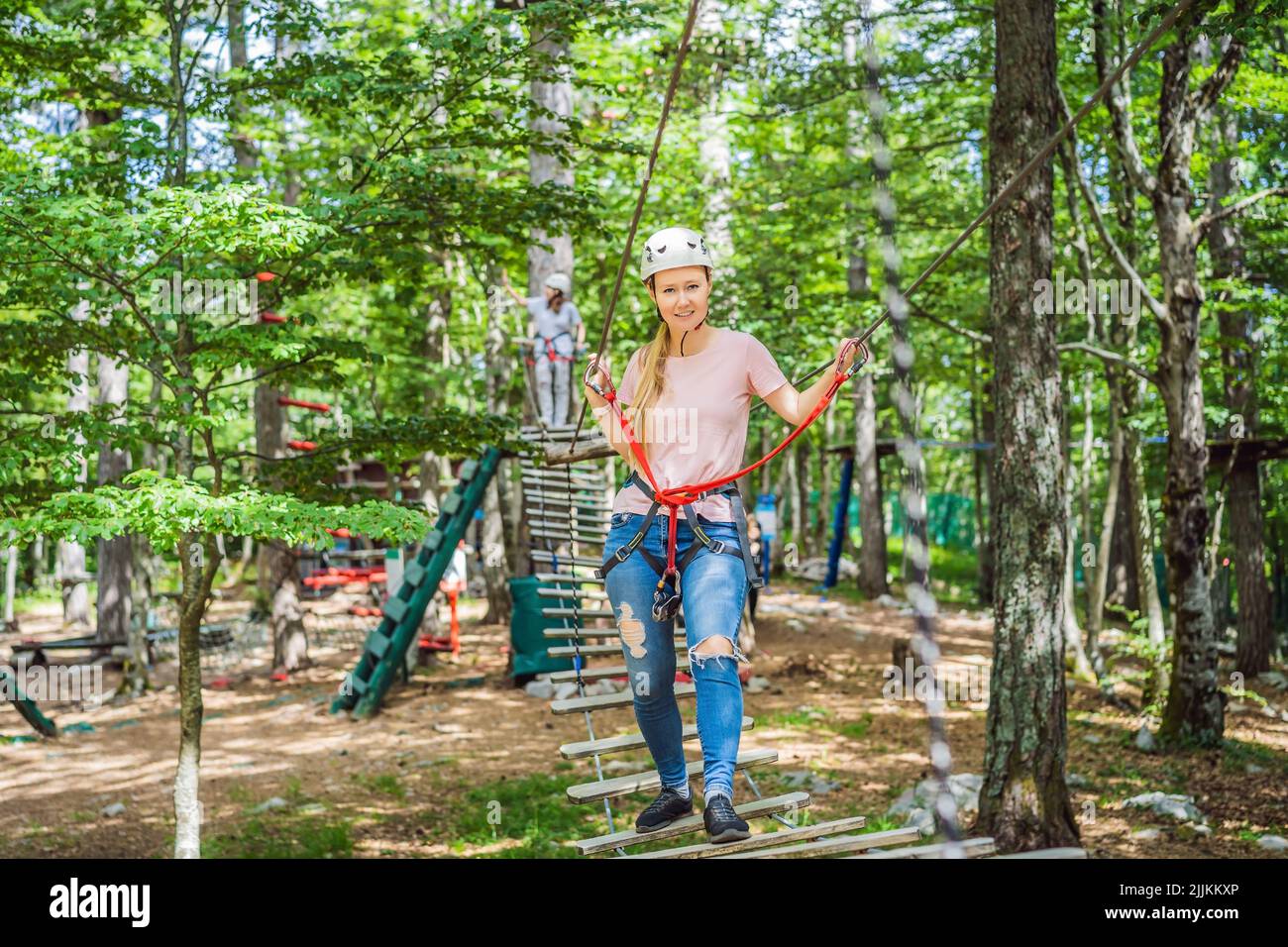Happy women girl female gliding climbing in extreme road trolley ...