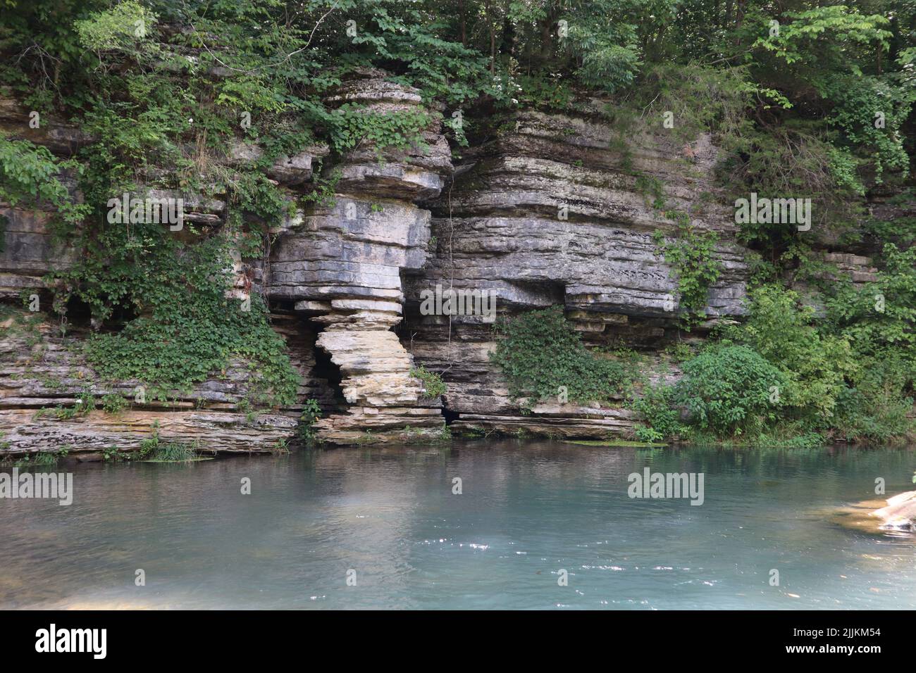 A scenic view of the Missouri River flowing through rocky banks covered ...