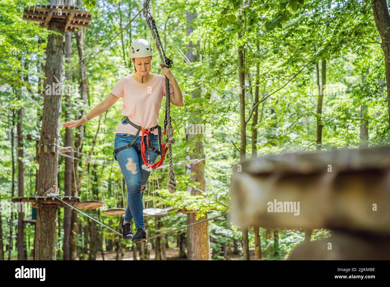 Happy women girl female gliding climbing in extreme road trolley ...