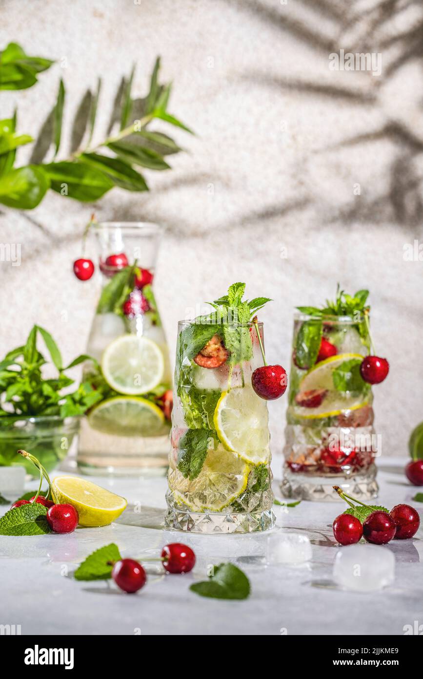 Cherry Mojito cocktail in highball glass or mocktails surrounded by ...