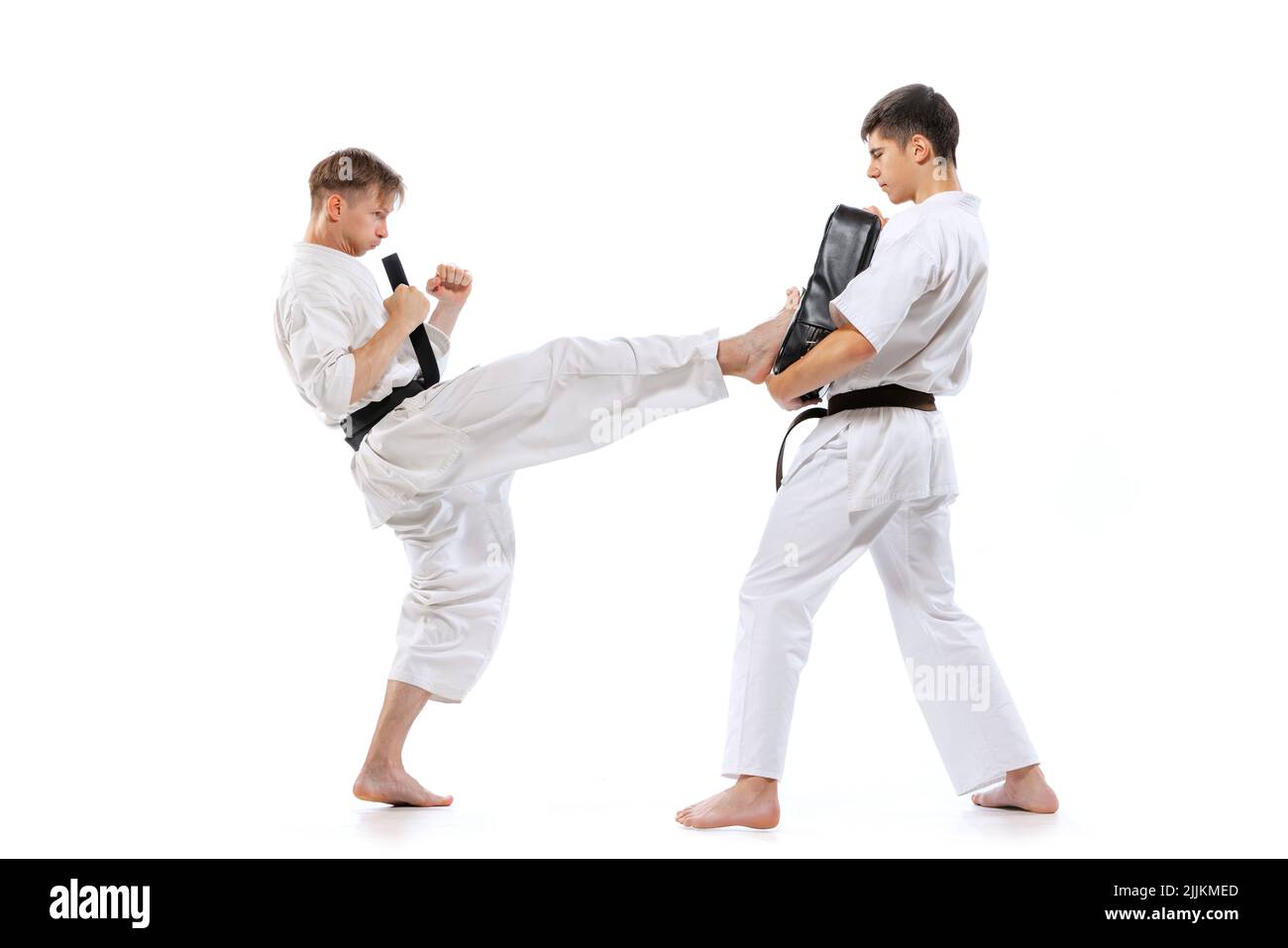 Two athletes, karate-do fighters in doboks practicing karate isolated ...