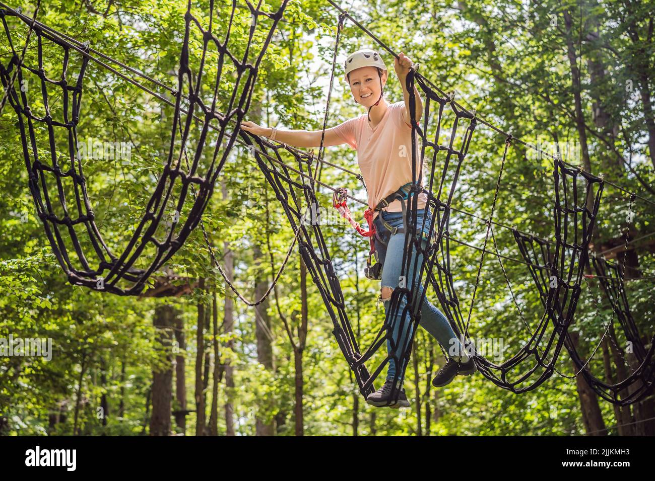 Happy women girl female gliding climbing in extreme road trolley ...