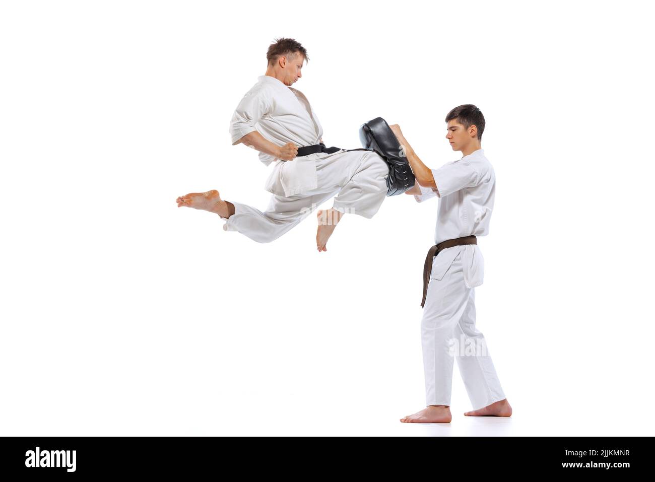 Two athletes, karate-do fighters in doboks practicing karate isolated ...