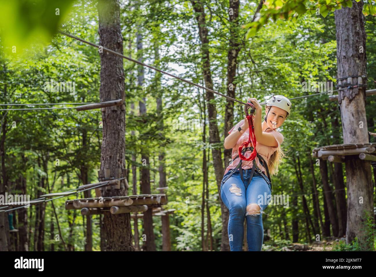 Happy women girl female gliding climbing in extreme road trolley ...
