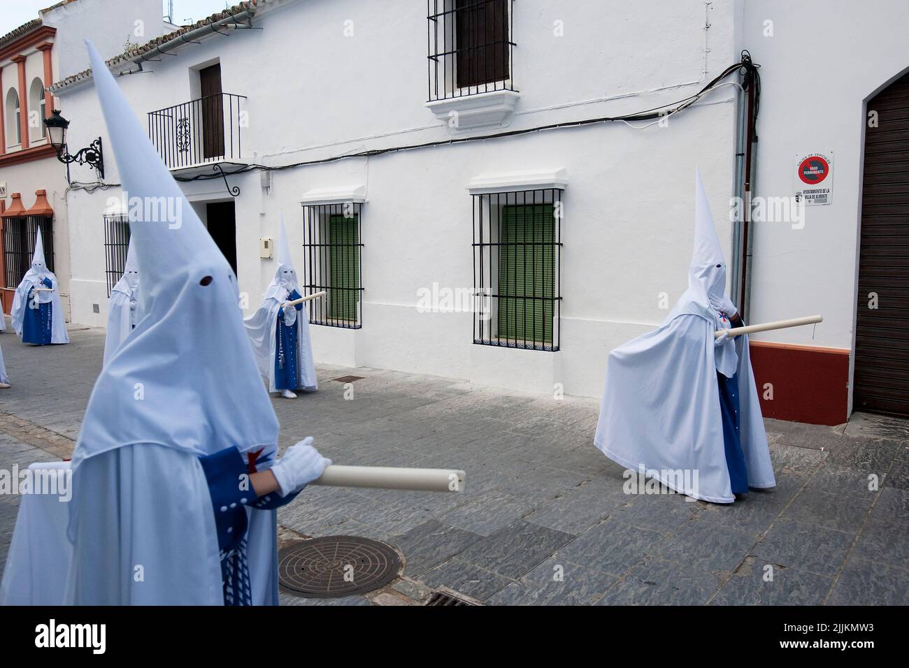 A group of people with white, traditional capirotes at the Spanish Holy ...