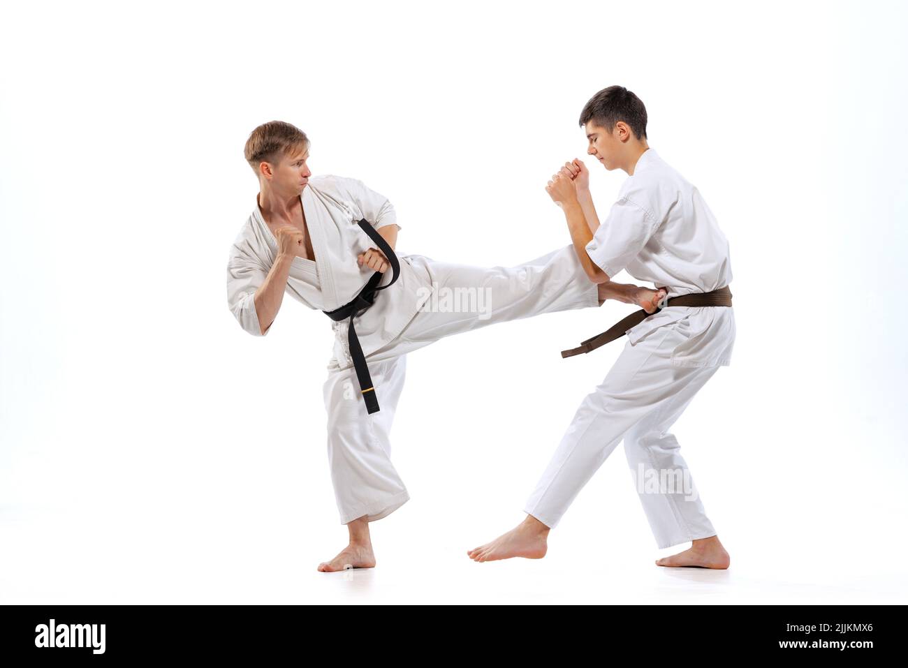 Two athletes, karate-do fighters in doboks practicing karate isolated ...