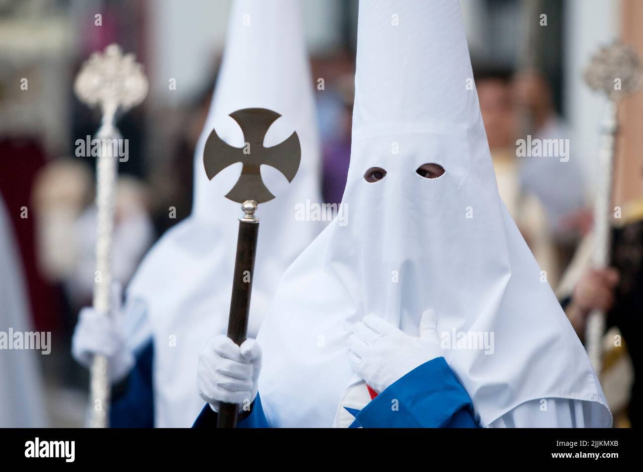 A portrait of a person with a traditional capirote and a cross at the ...