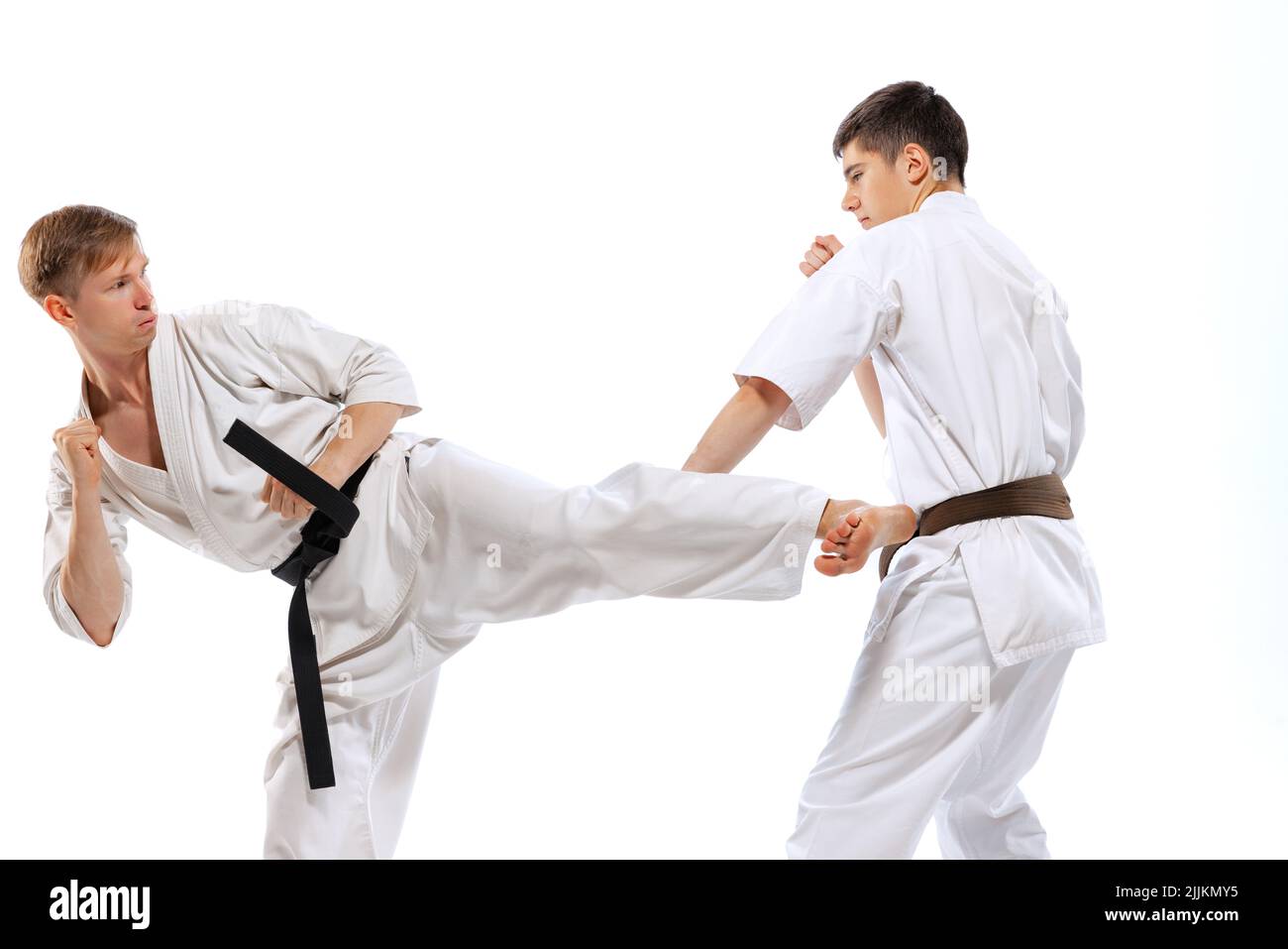 Two athletes, karate-do fighters in doboks practicing karate isolated ...