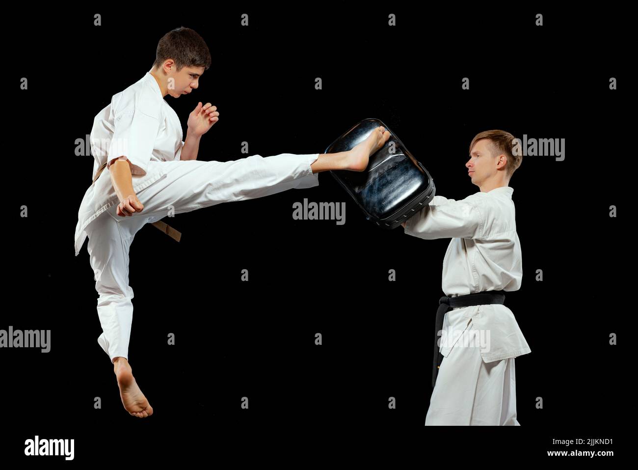 Dynamic portrait of male karate-do fighters in sports uniform training ...
