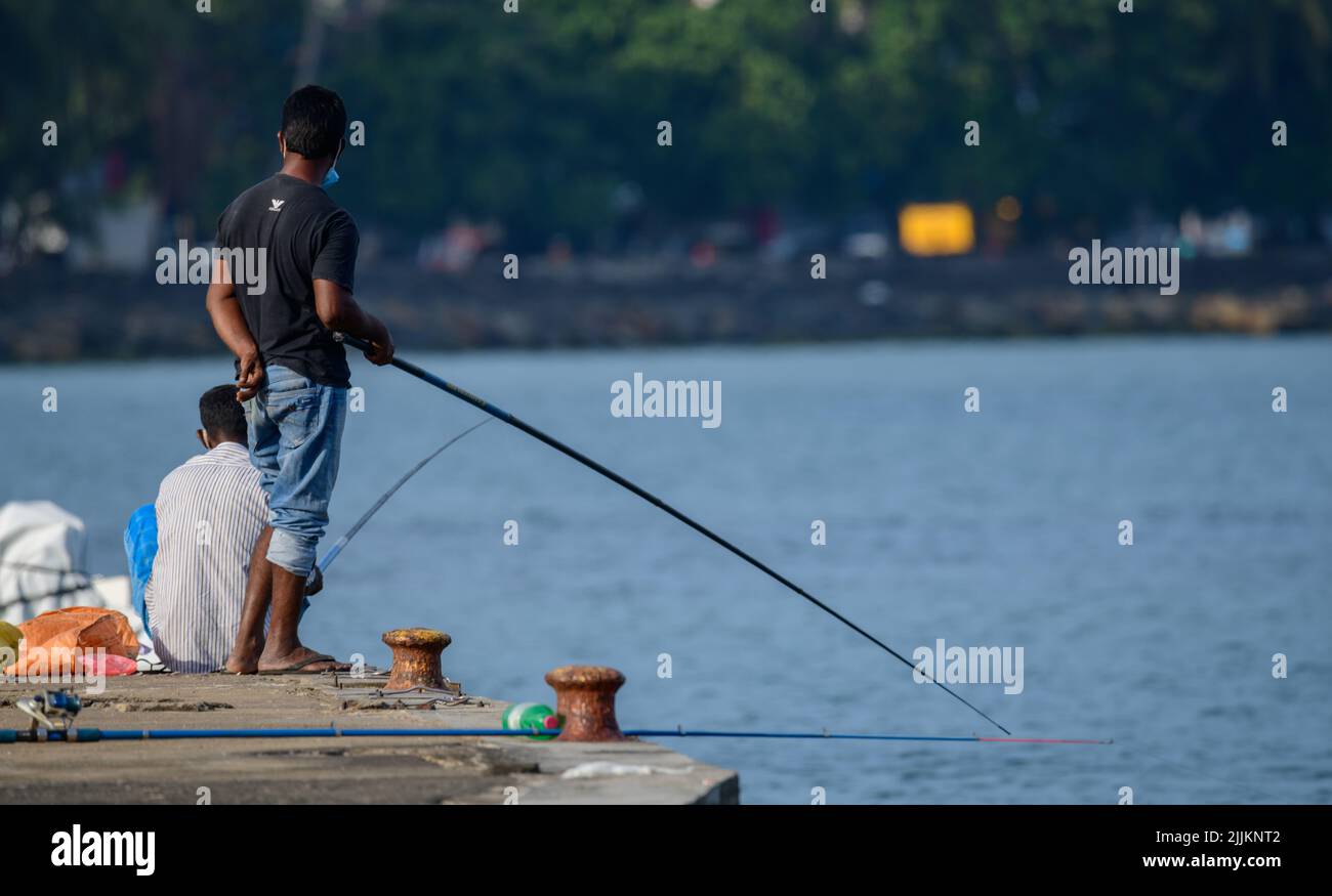 Two male fishermen fishing rods hi-res stock photography and images - Alamy
